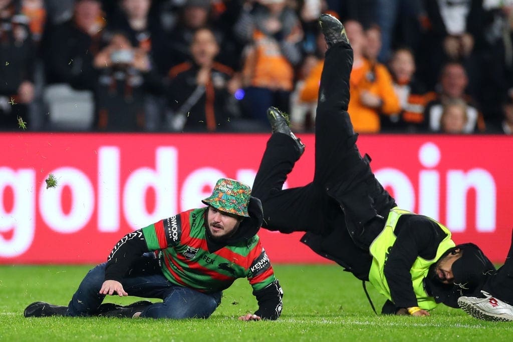 WATCH: Bankwest Stadium streaker dodges then upends security guard ...